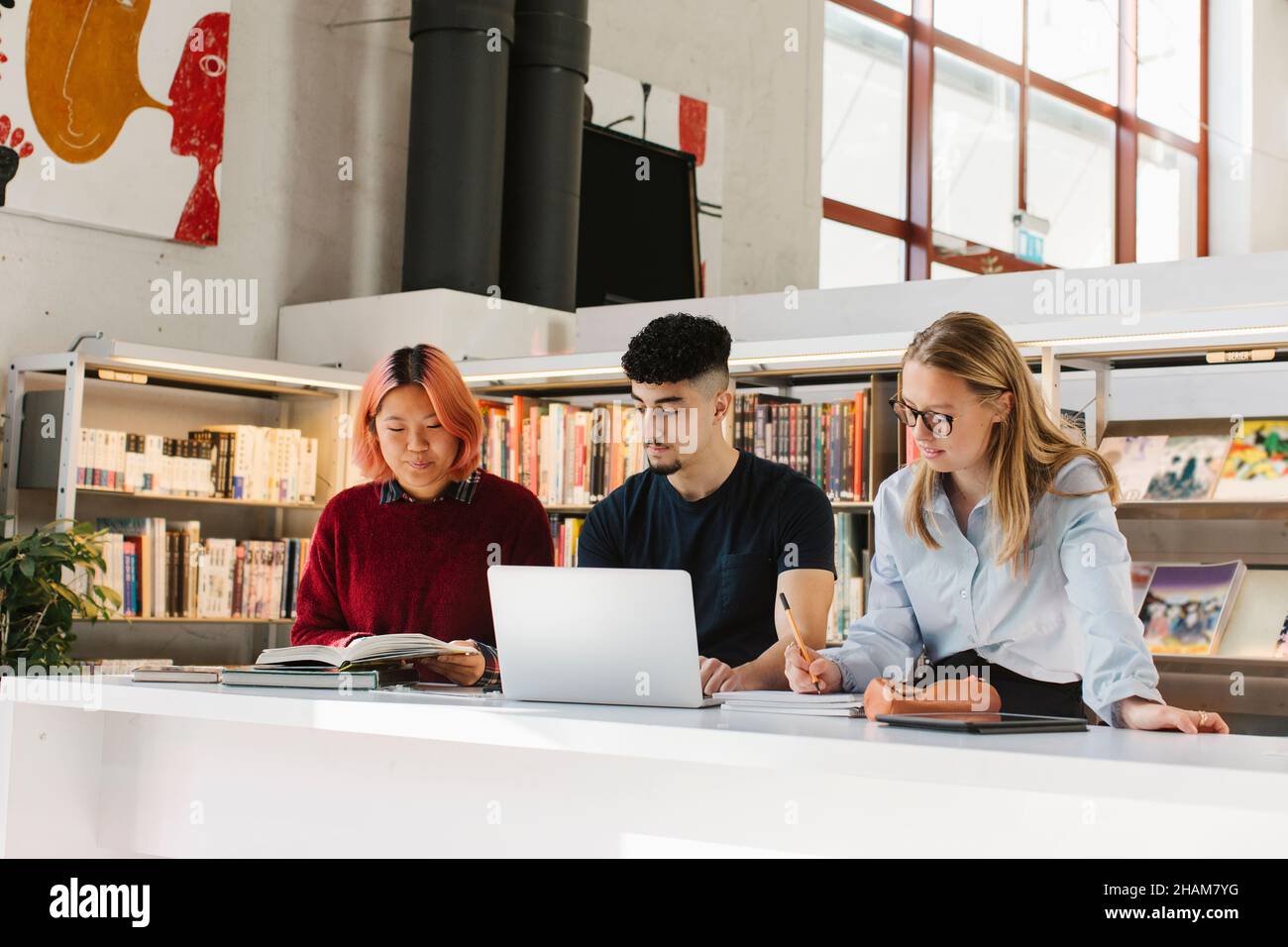 Young people studying in library Stock Photo - Alamy