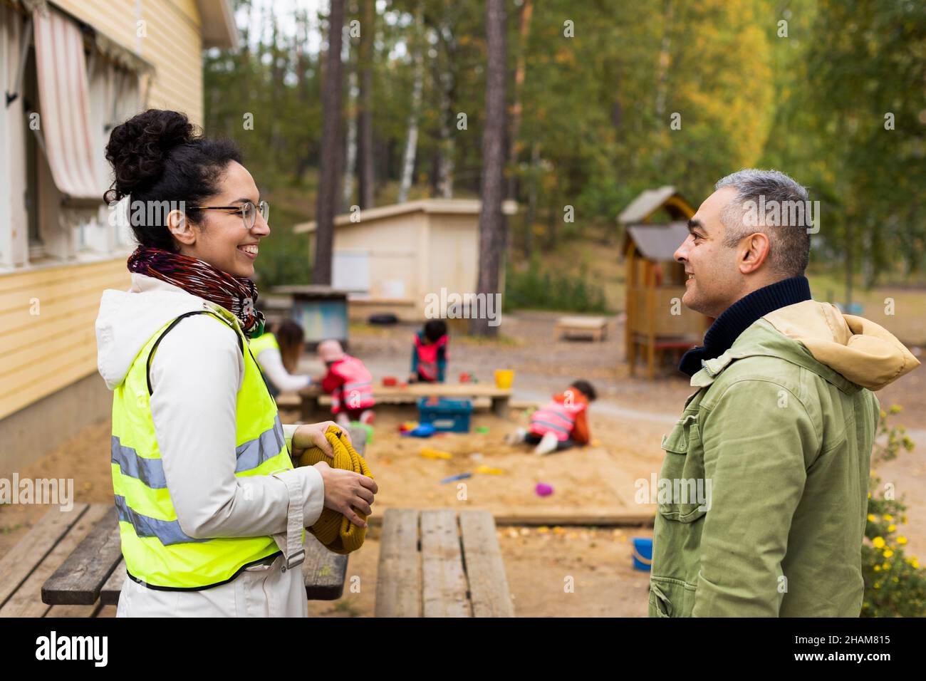 Preschool teacher talking to parent Stock Photo - Alamy