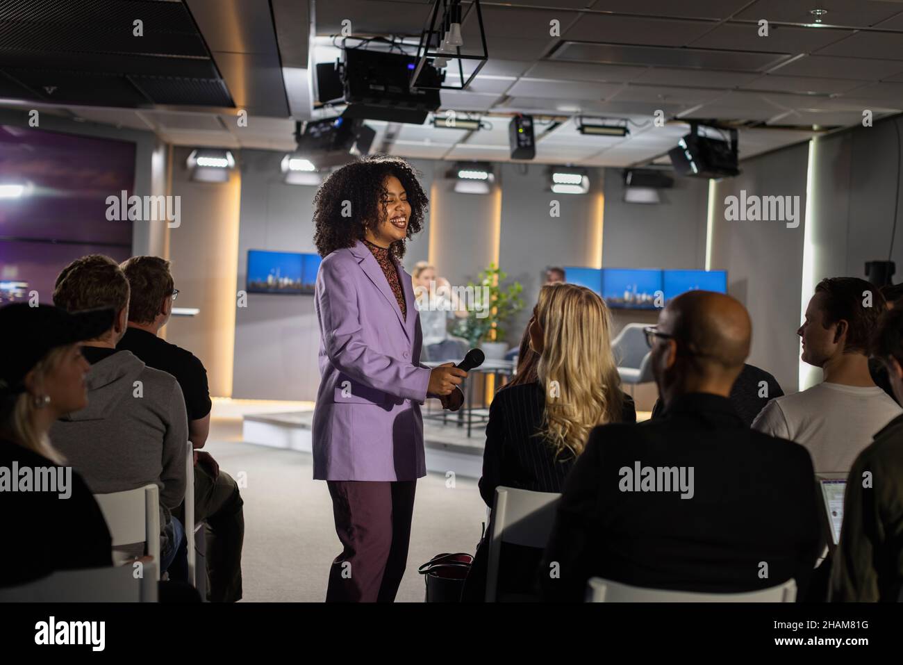 TV show host interviewing audience member Stock Photo - Alamy