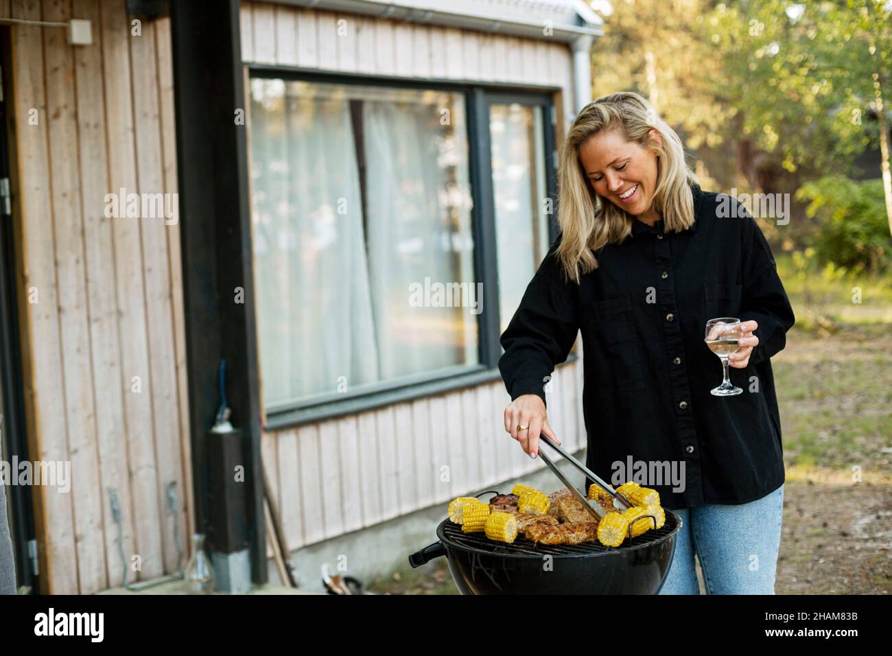 Women having barbecue on patio Stock Photo - Alamy