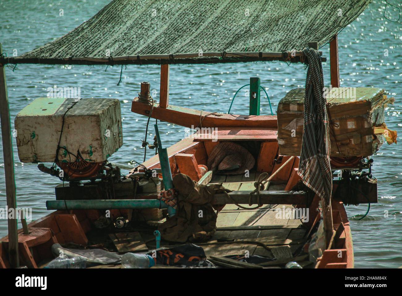 Traditional Khmer fishing boat on the water waves Stock Photo - Alamy