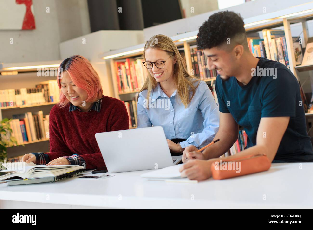 Young people studying in library Stock Photo - Alamy