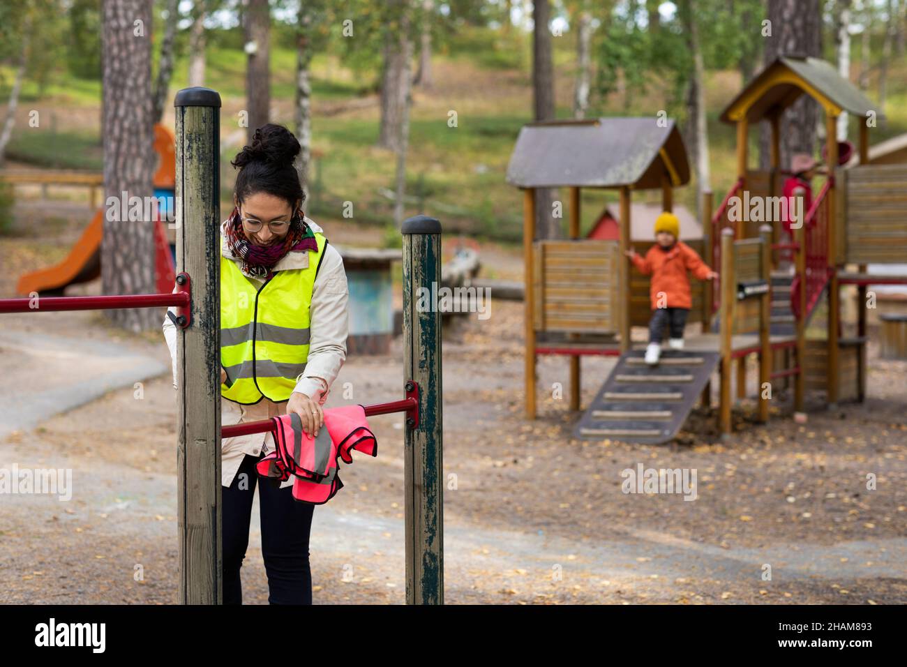 Preschool teacher in reflective vest at playground Stock Photo - Alamy