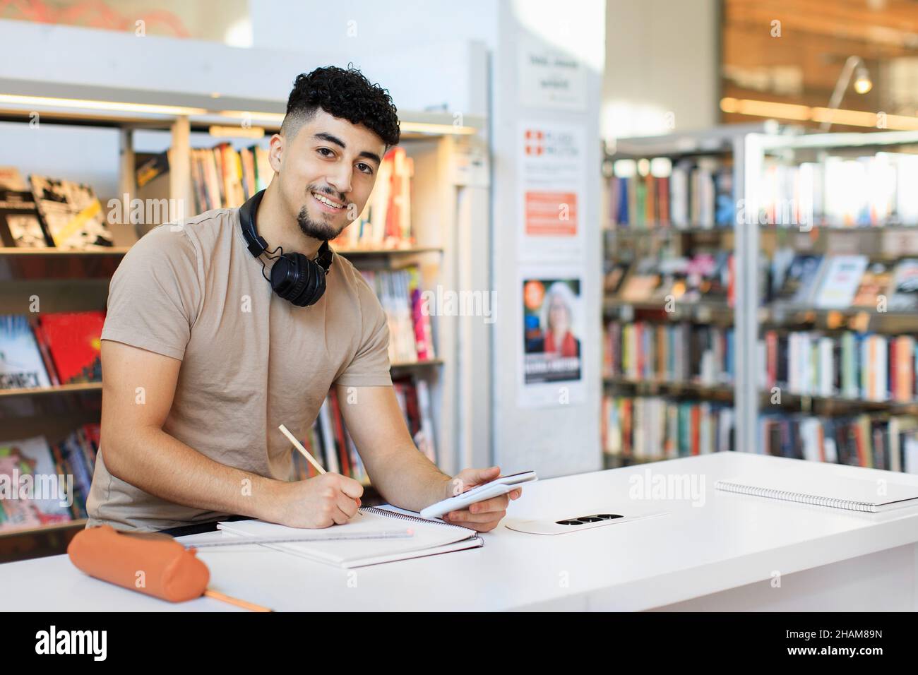 Young man studying in library Stock Photo - Alamy