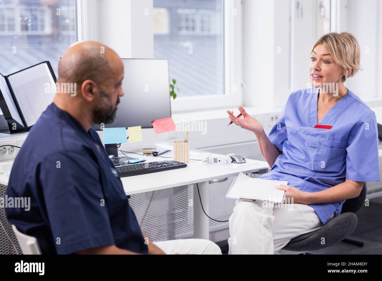 Doctors talking in office Stock Photo - Alamy