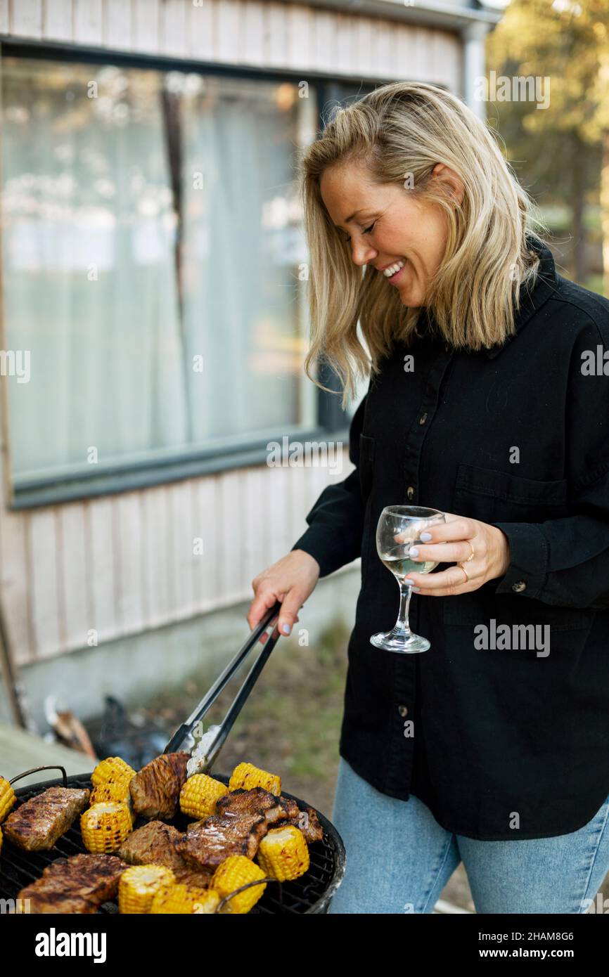 Women having barbecue on patio Stock Photo - Alamy
