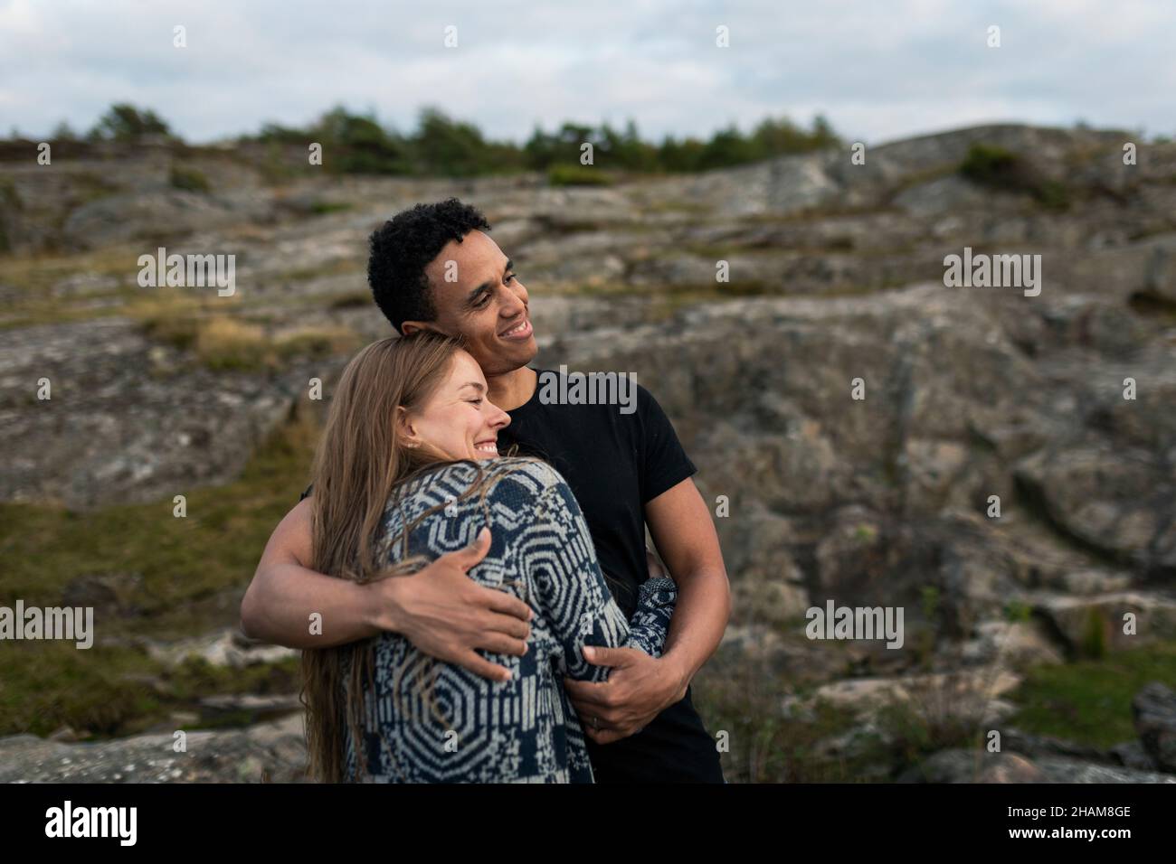 Smiling couple hugging in nature Stock Photo - Alamy