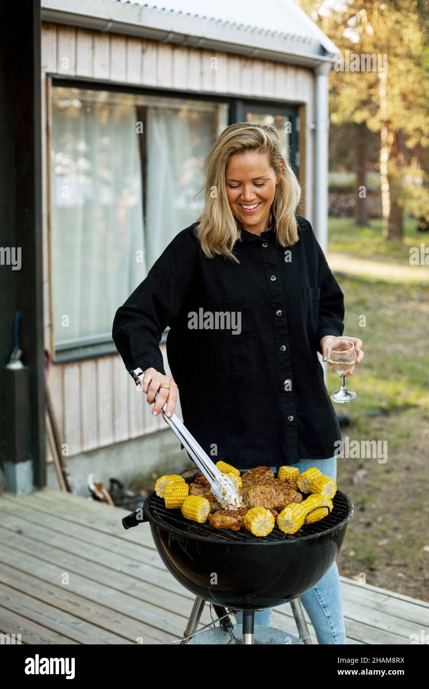 Women having barbecue on patio Stock Photo - Alamy