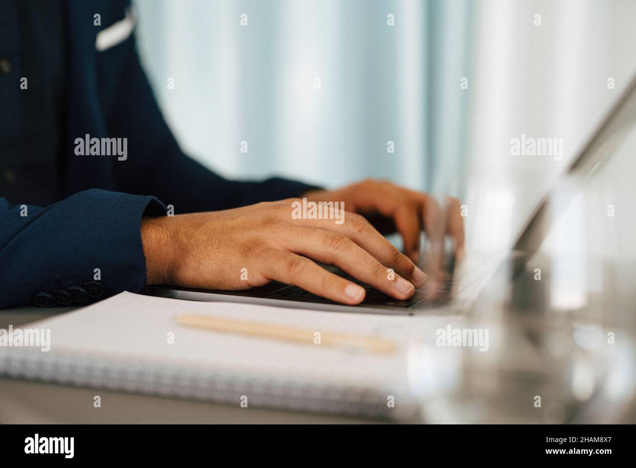 Man's hands on laptop keyboard Stock Photo - Alamy