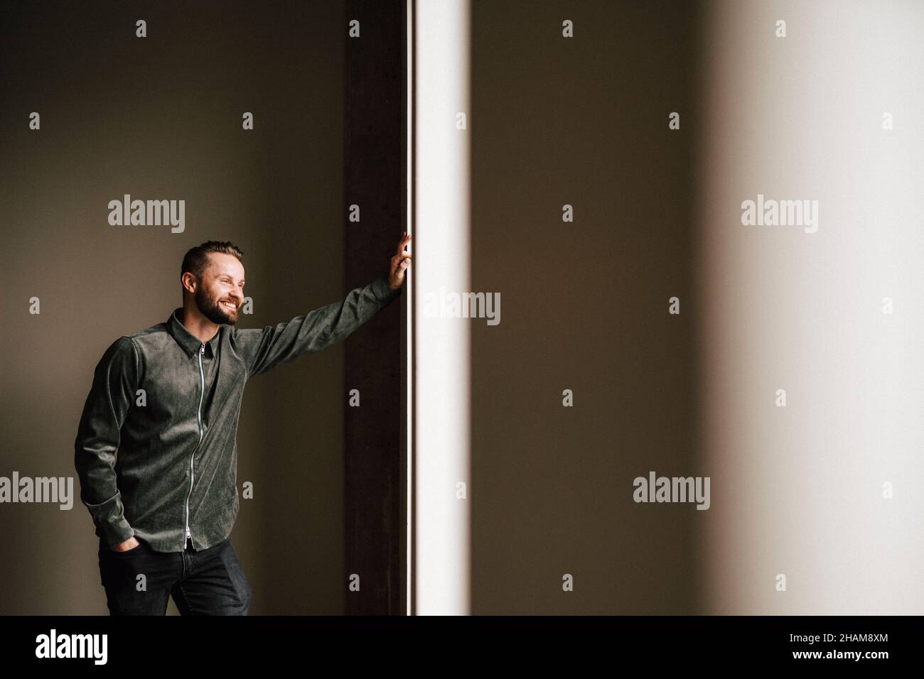 Man looking through window Stock Photo - Alamy