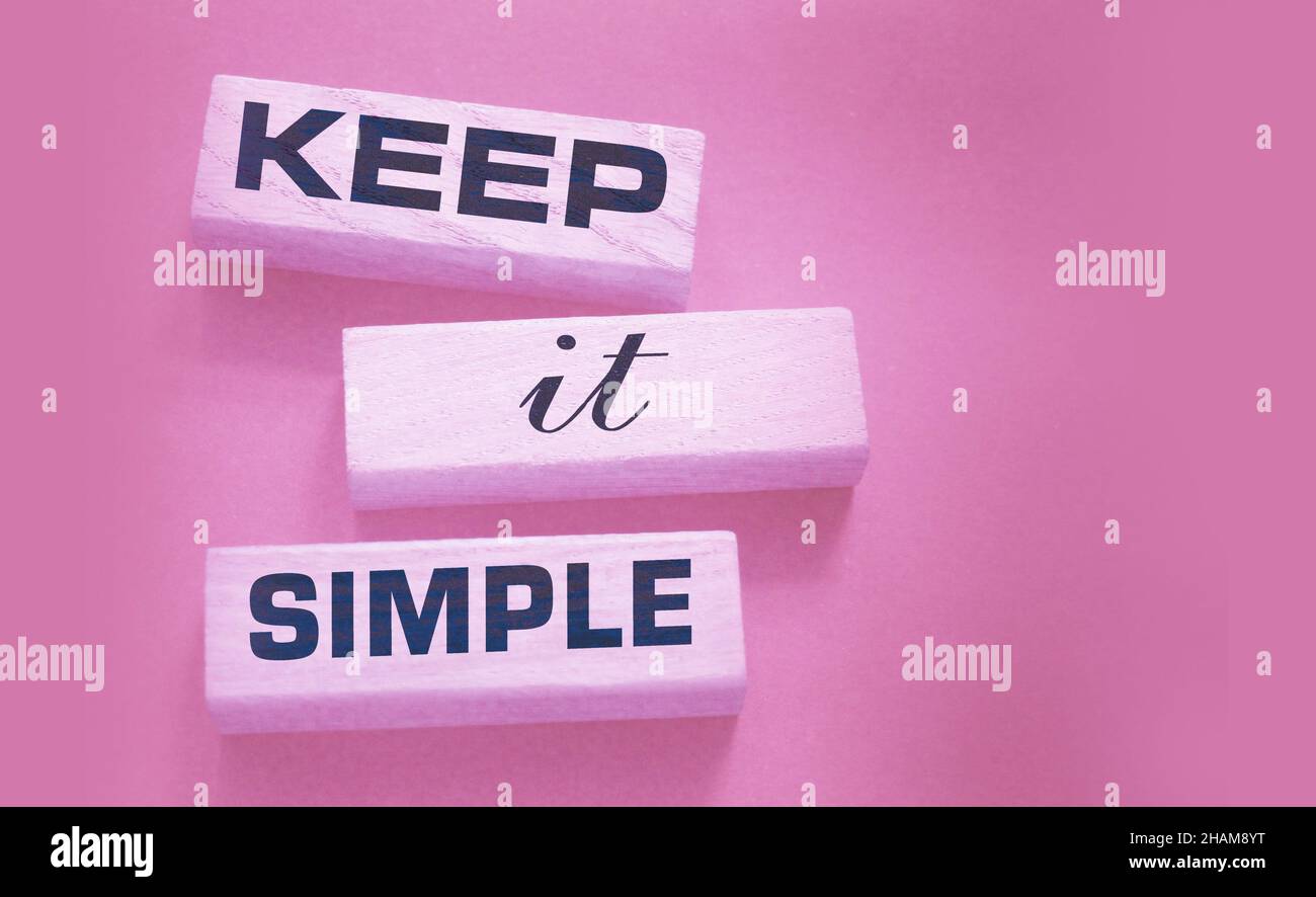 Keep it simple words on wooden blocks on dark gray background. Business ...
