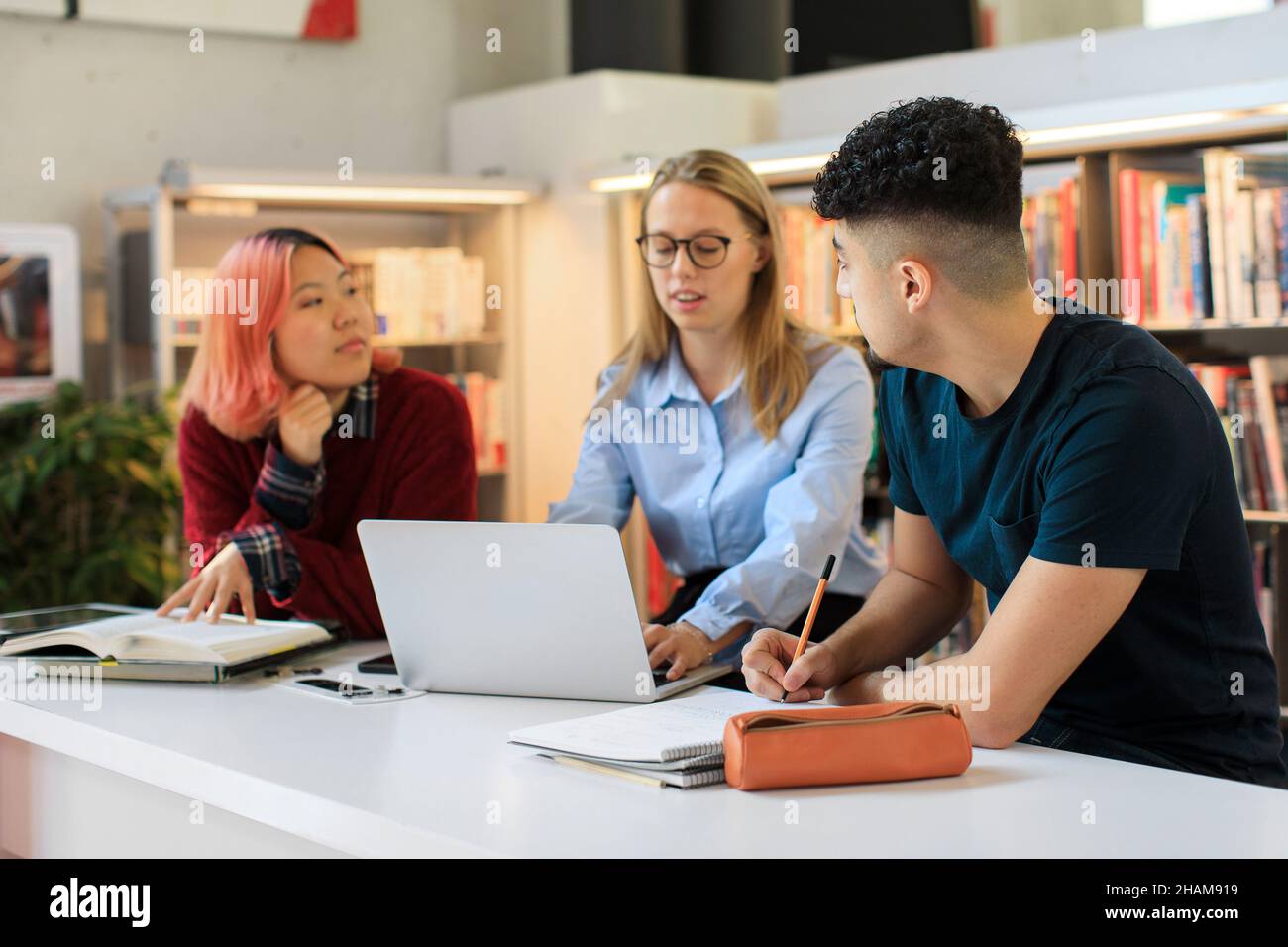 Young people studying in library Stock Photo - Alamy