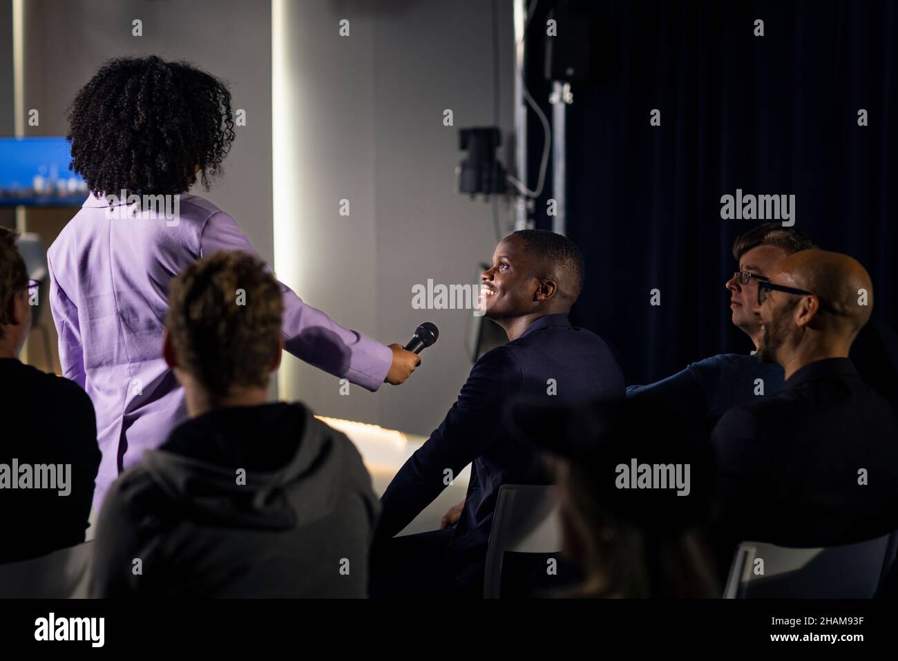 TV show host interviewing audience member Stock Photo - Alamy