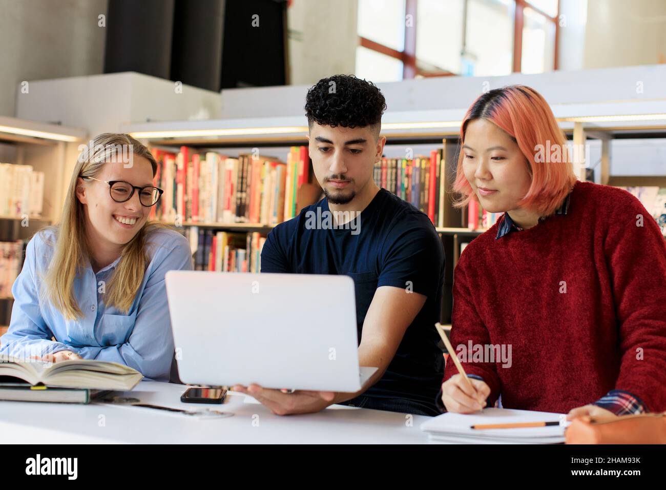 Young people studying in library Stock Photo - Alamy