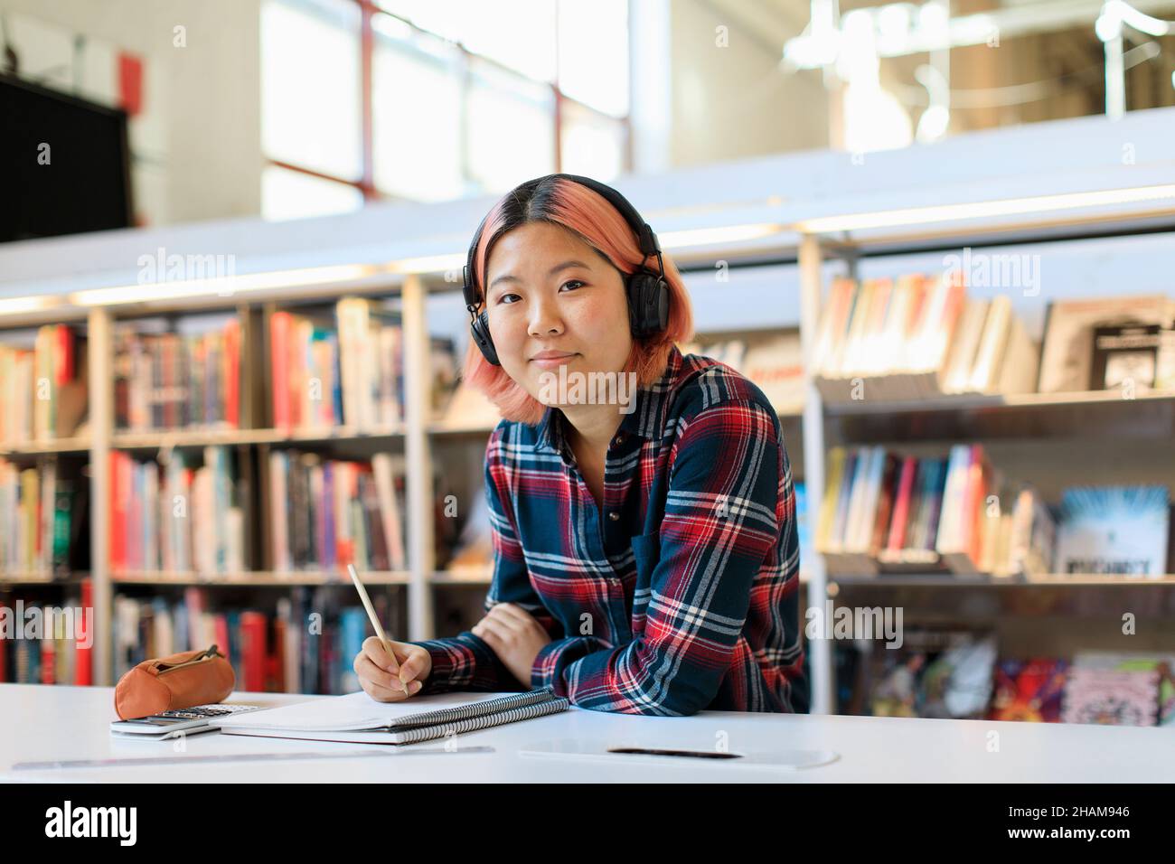 Studying in library with headphones hi-res stock photography and images ...