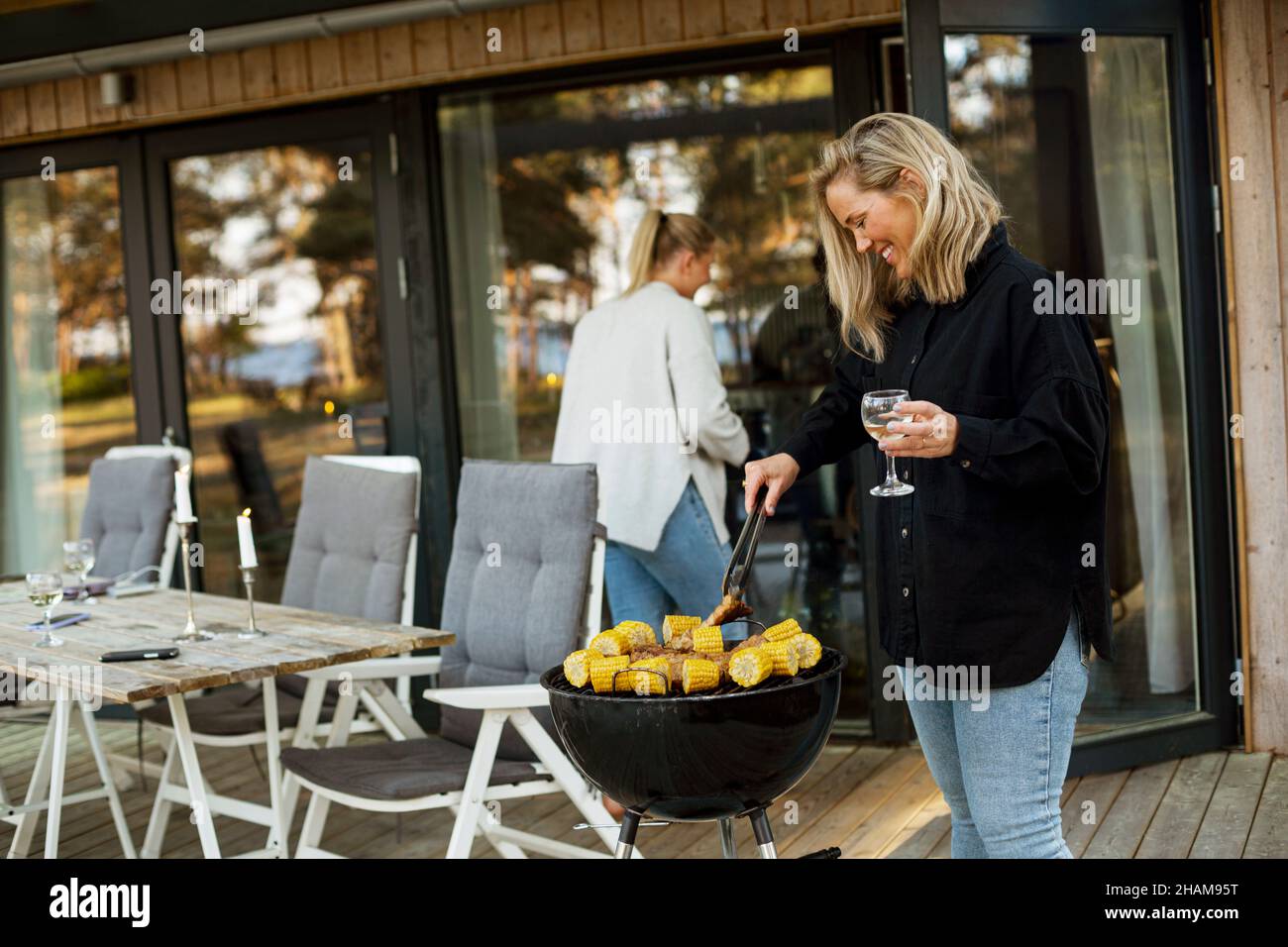Women having barbecue on patio Stock Photo - Alamy