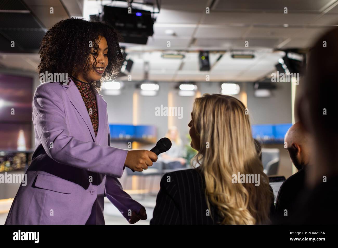 TV show host interviewing audience member Stock Photo - Alamy