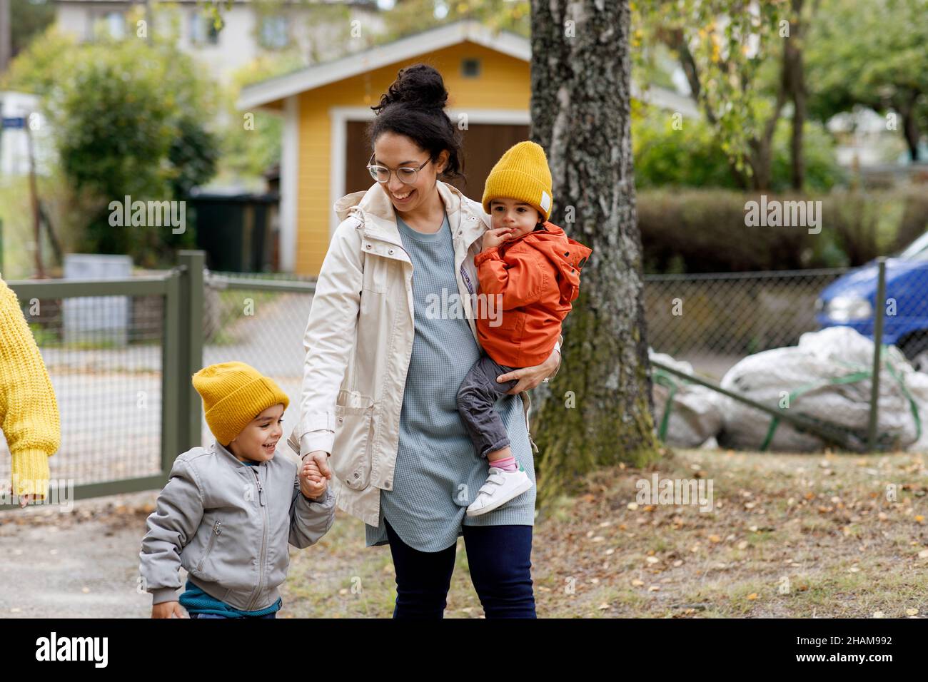 Mother walking with two children Stock Photo - Alamy