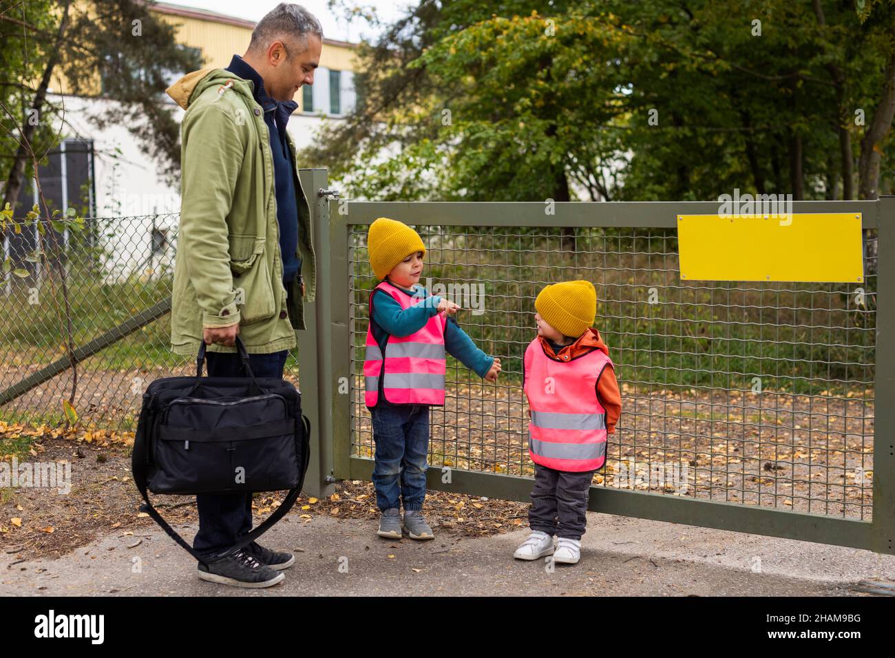 Father collecting children from school Stock Photo - Alamy