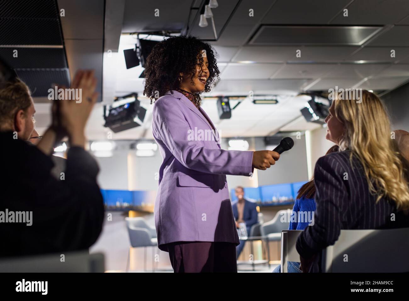 TV show host interviewing audience member Stock Photo - Alamy