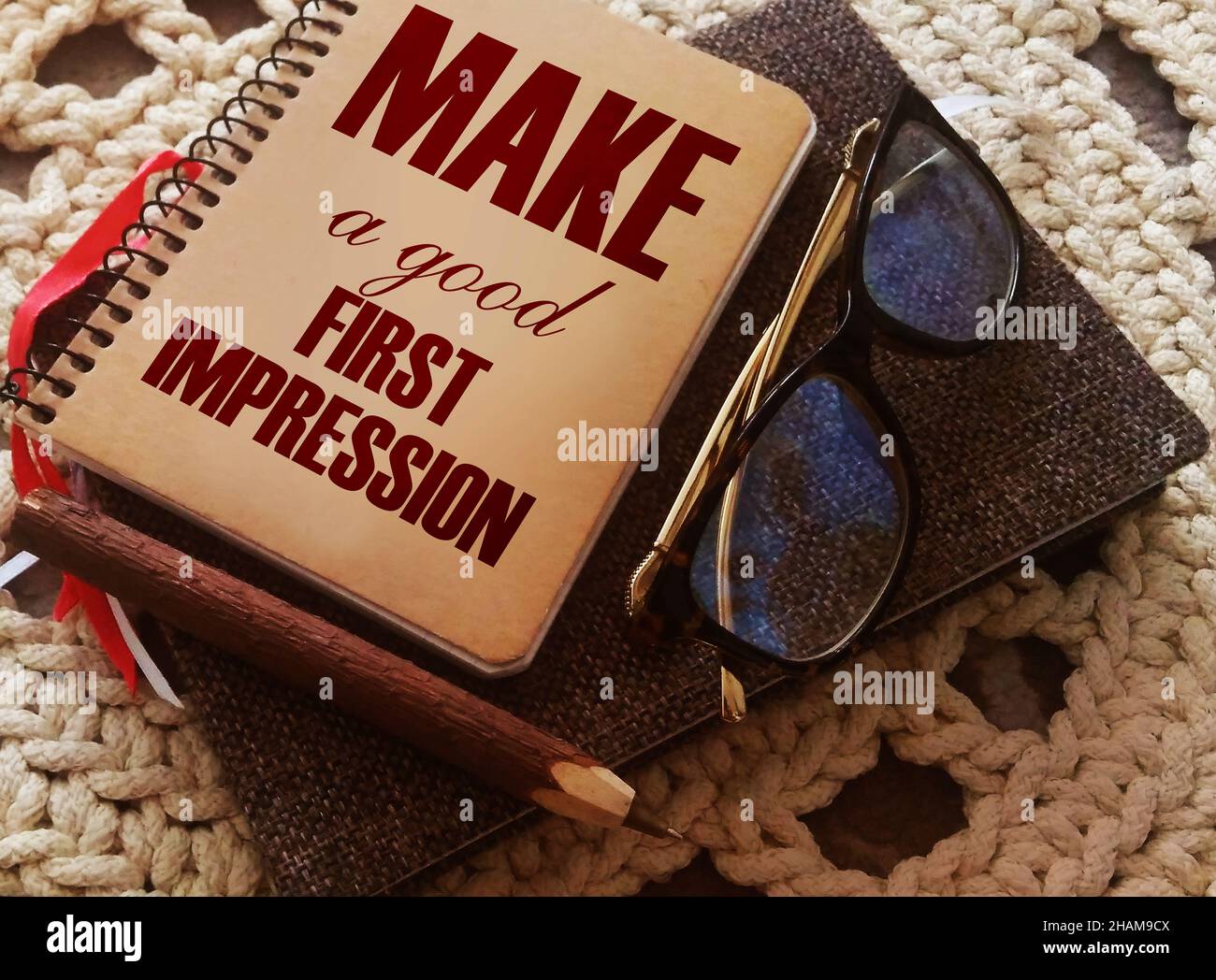 Make a Good First Impression written on book cover, eyeglasses and pen ...