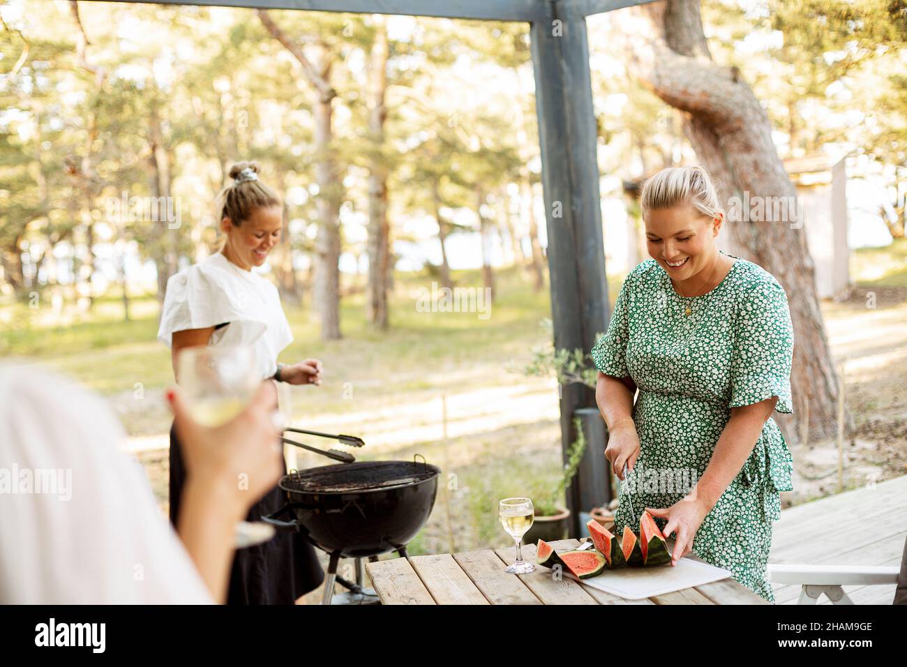 Women having barbecue on patio Stock Photo - Alamy