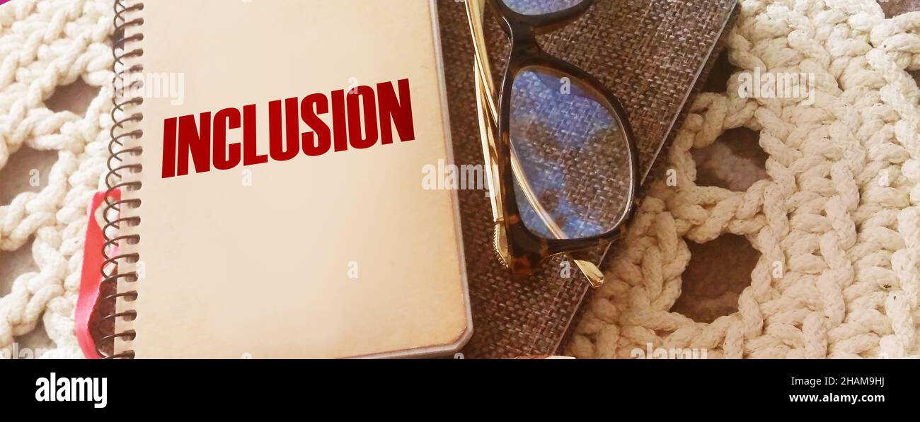 Book with text inclusion, glasses and pen on beautiful crochet carpet ...