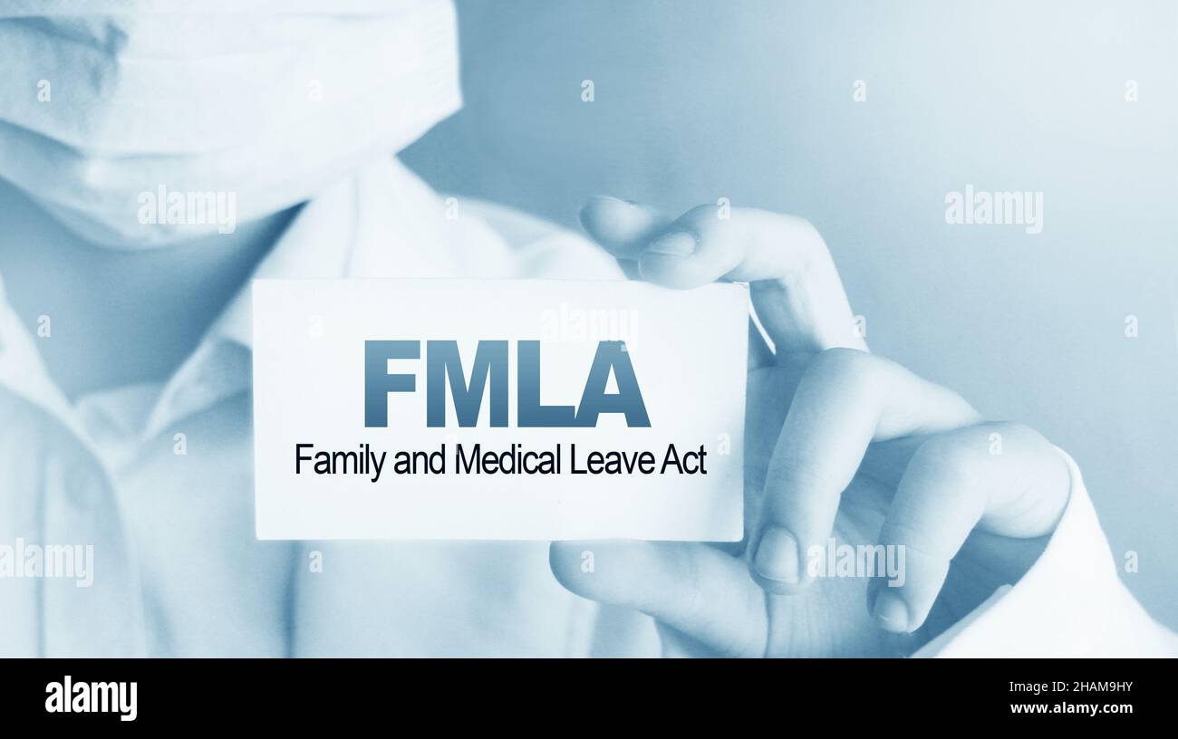 Doctor holding a card with text FMLA medical concept Stock Photo - Alamy