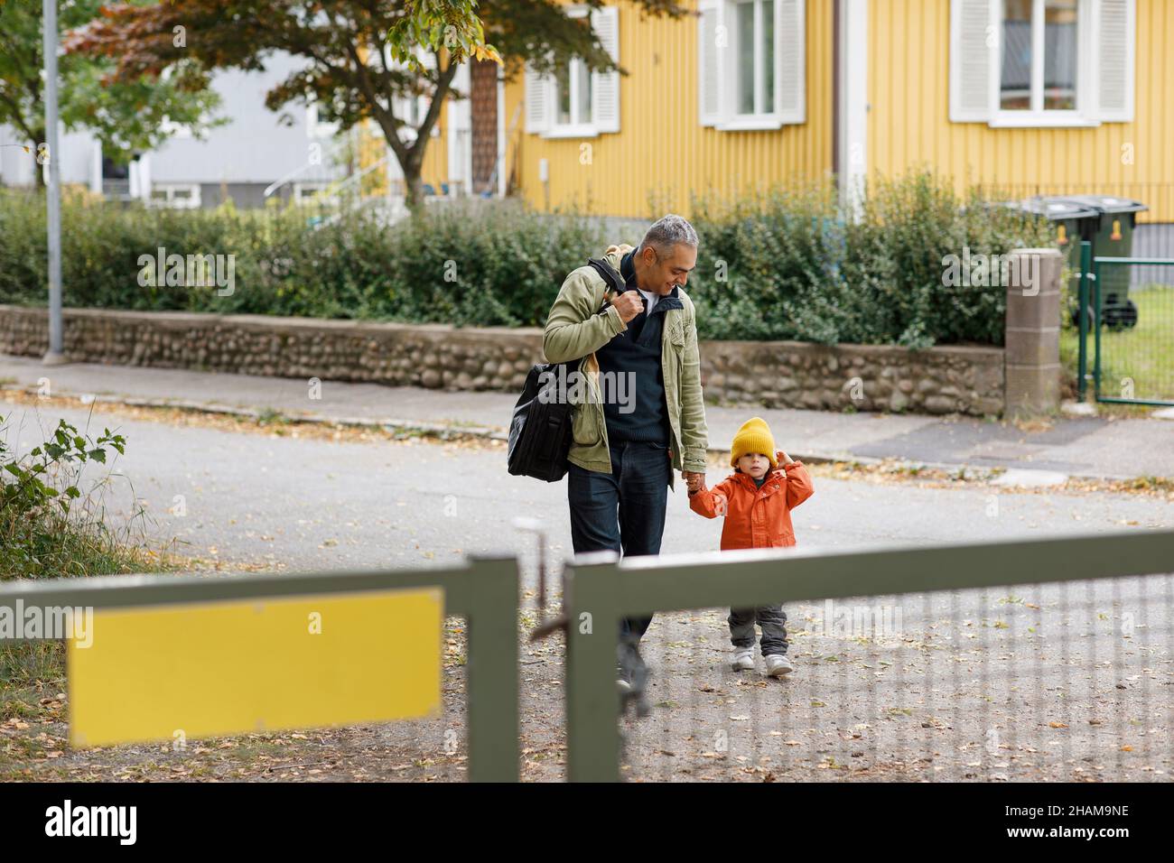 Father walking with child Stock Photo - Alamy