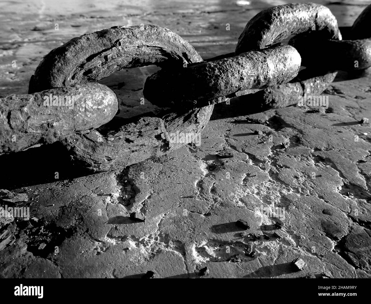 Black and white photograph of thick chain on concrete Stock Photo - Alamy