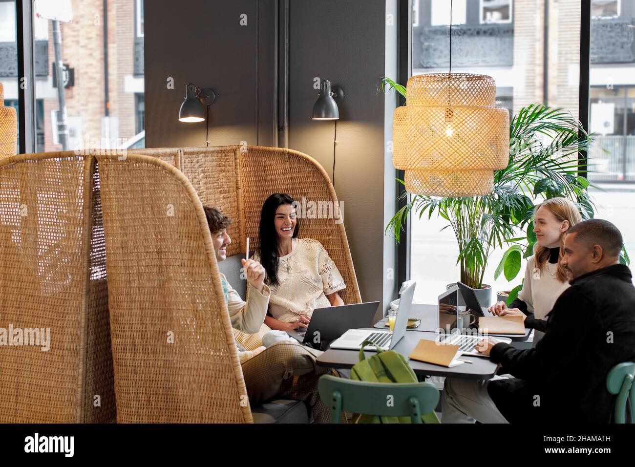 Young coworkers talking together Stock Photo - Alamy