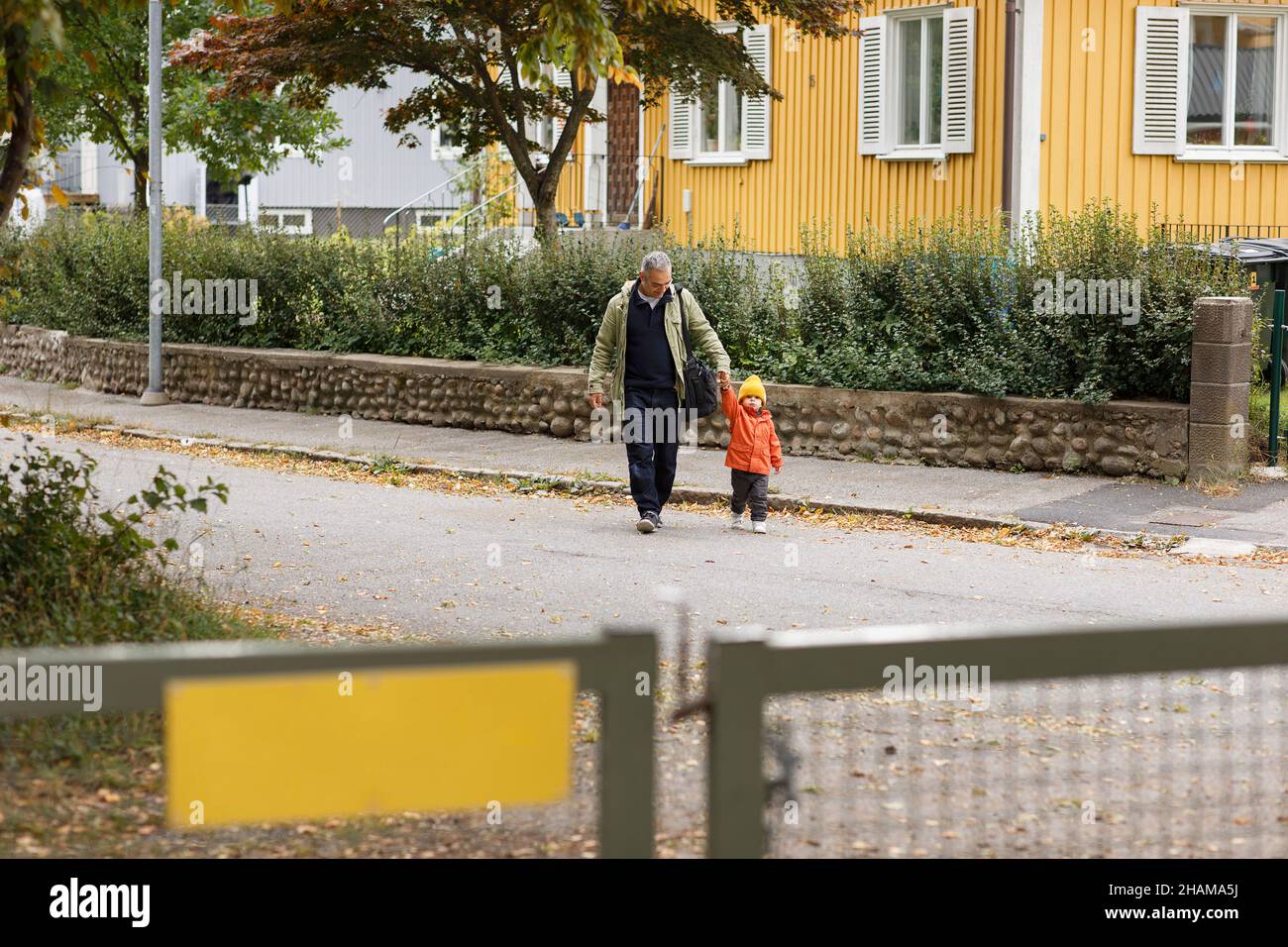 Father walking with child Stock Photo - Alamy