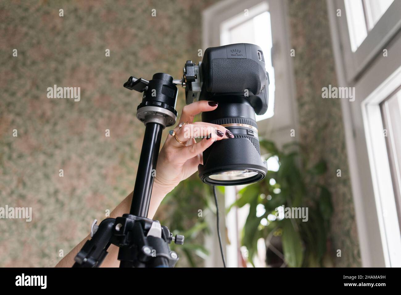Woman's hand adjusting camera Stock Photo - Alamy