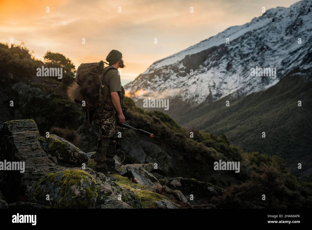 Hunter looking at mountains Stock Photo - Alamy