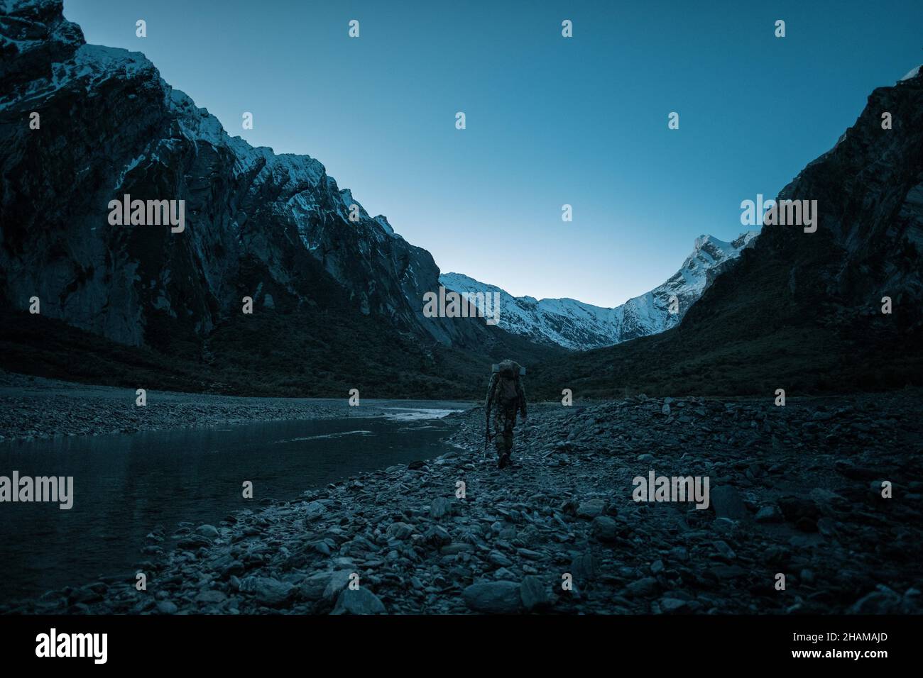Rear view of hunter in mountains Stock Photo - Alamy