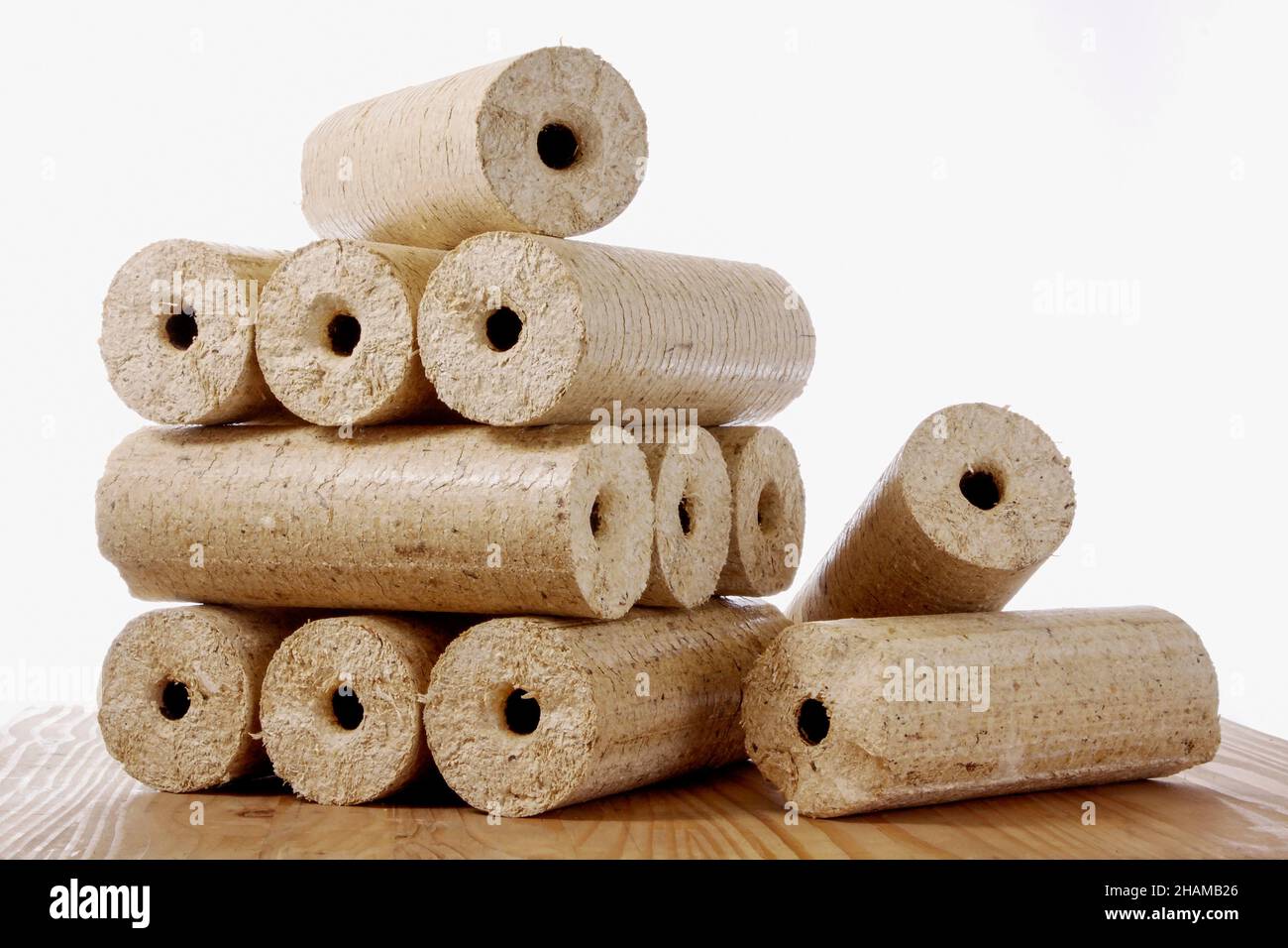 round wooden briquettes isolated against a white background Stock Photo ...