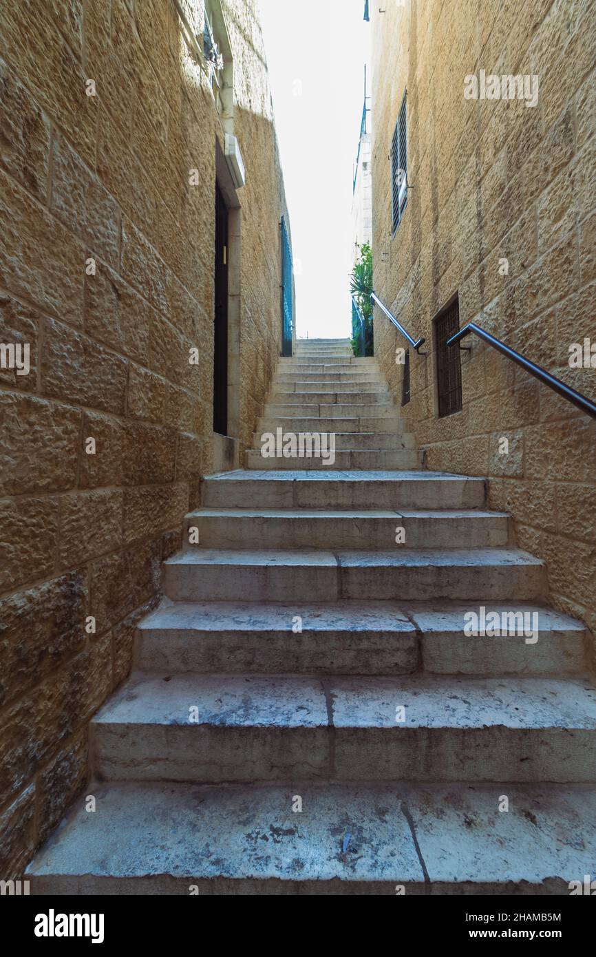 Narrow stone steps in an alley in the Jewish Quarter, with a handle for ...