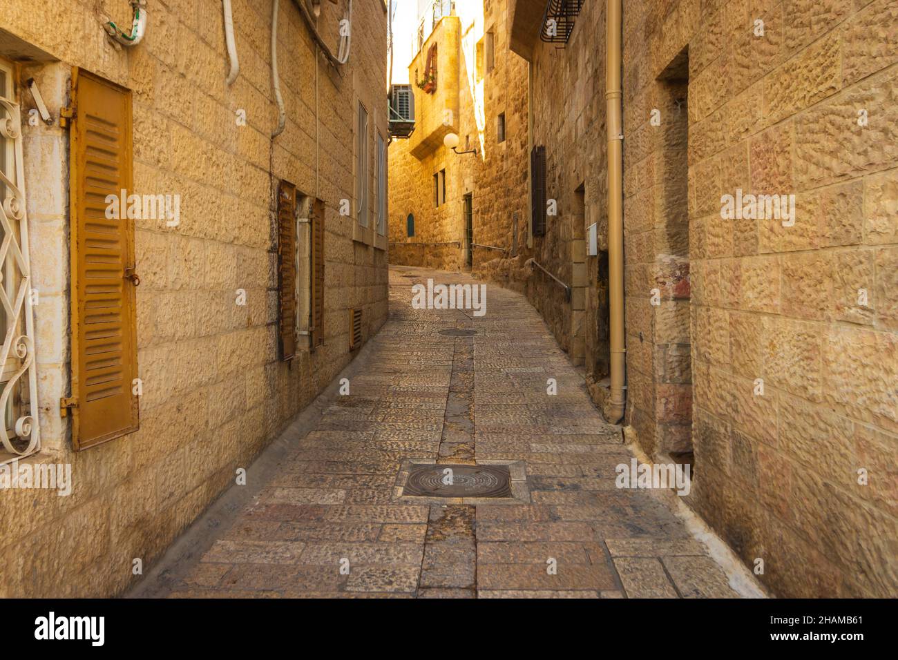 A narrow alley paved with ancient stones on an old and beautiful street ...