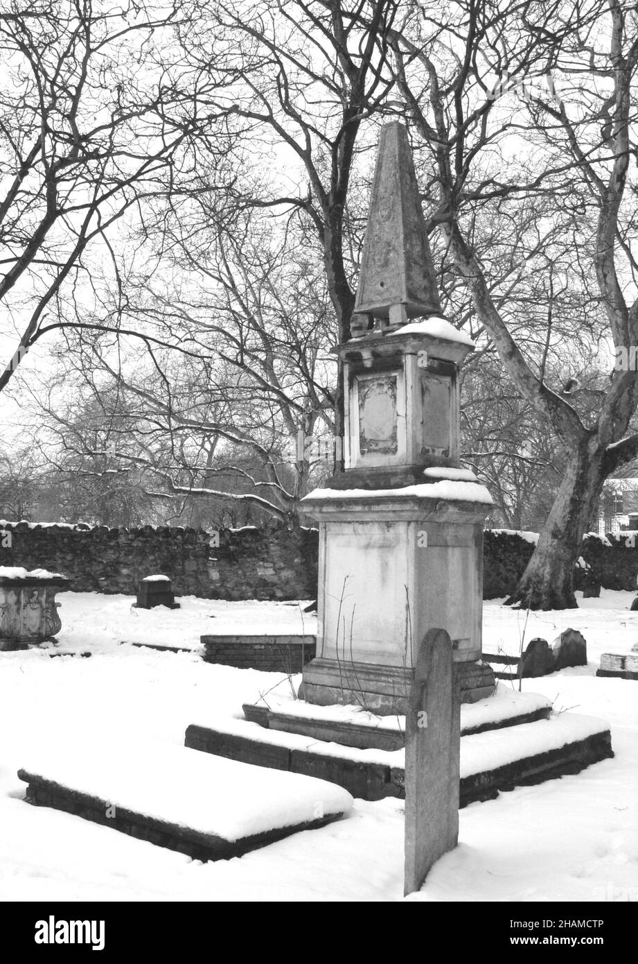 Scenic shot of a snow-covered graveyard in winter, taken in black and ...