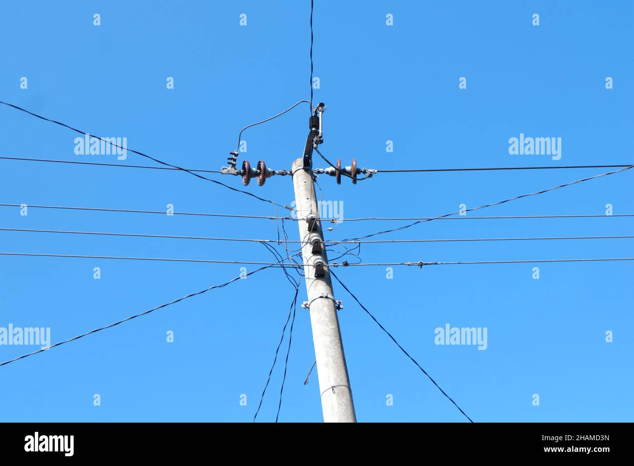 Low angle shot of an electrical power pole with wires connecting to it ...