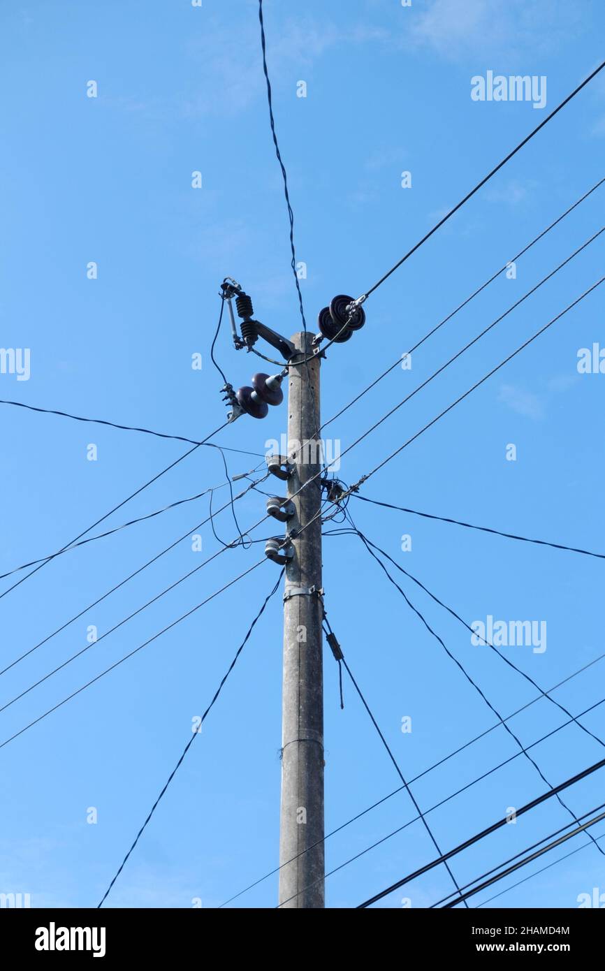 Inclined shot of an electrical power pole with many wires and cables ...