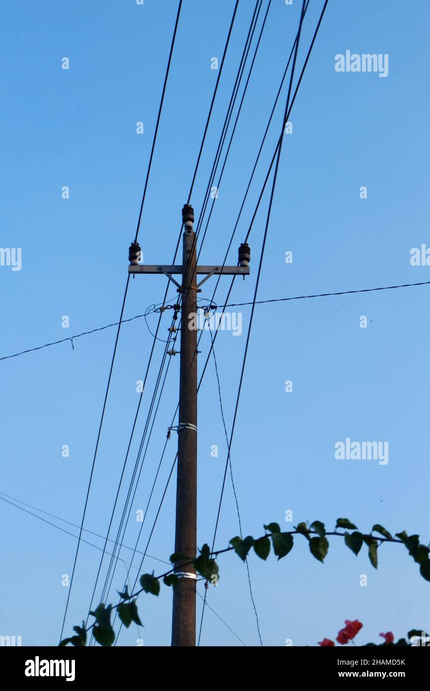 Inclined shot of an electrical power pole with wires connecting to it ...