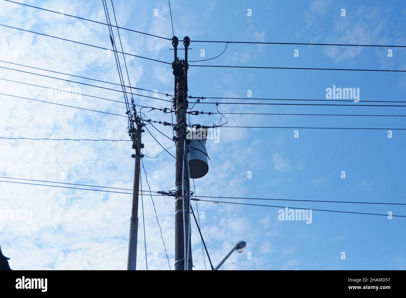 Electrical power pole with many wires and cables connecting to it with ...