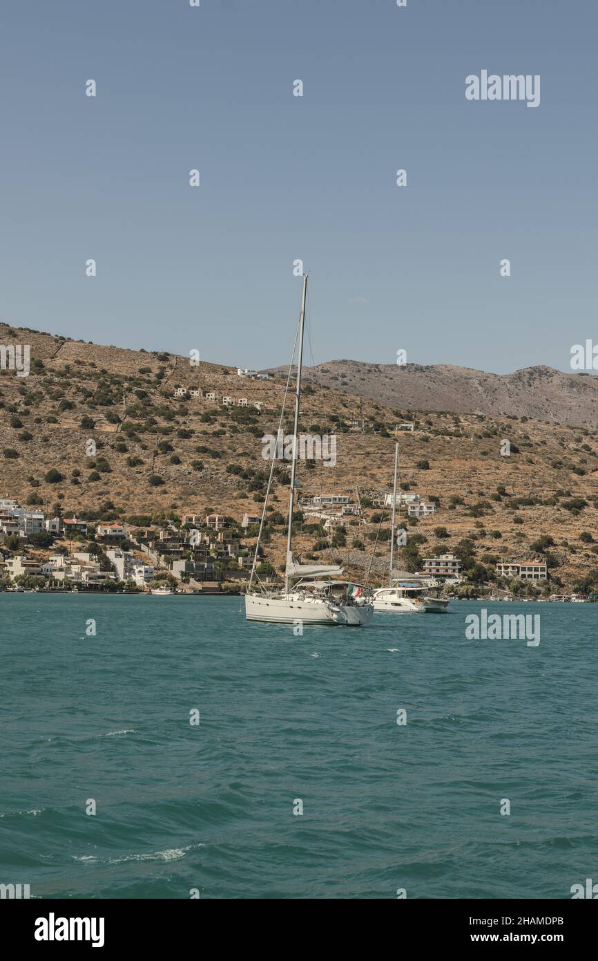 Beautiful scene with sailboats floating along the Crete island ...