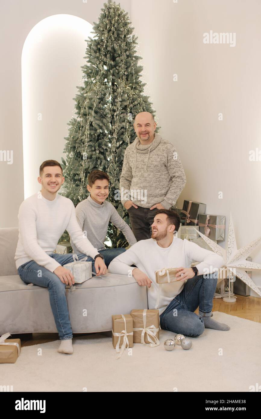 Young father with three sons. Big family at Christmas eve. Only man ...