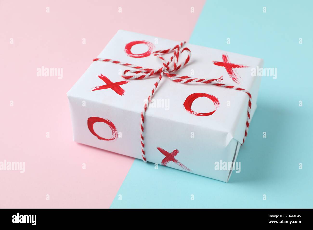 Gift box with XO on two tone background Stock Photo - Alamy
