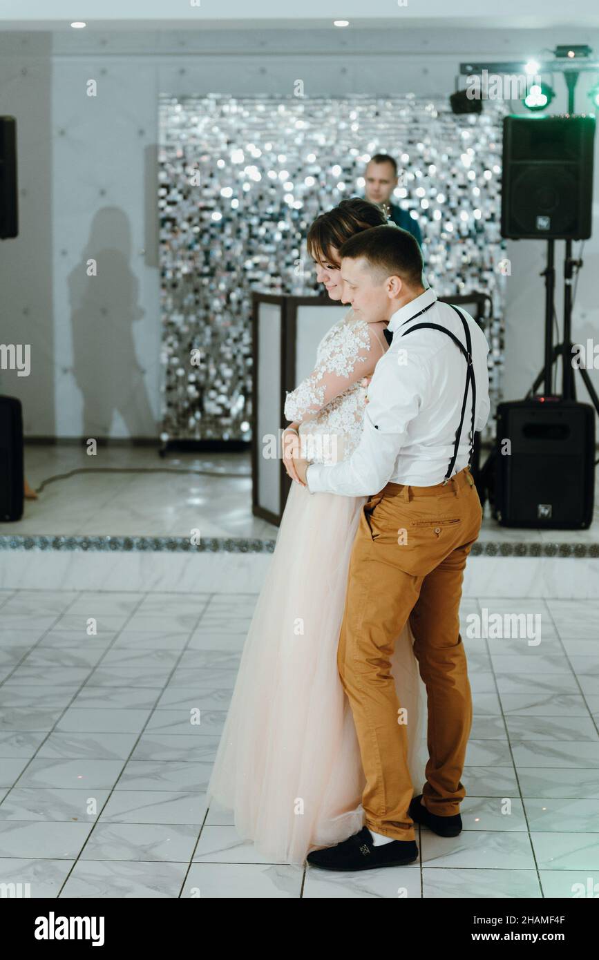 beautiful caucasian couple just married and dancing their first dance ...