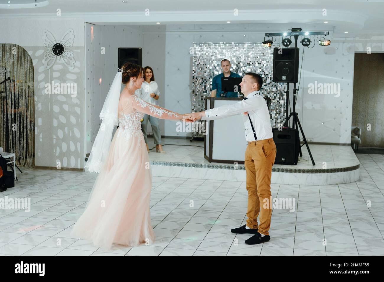 beautiful caucasian couple just married and dancing their first dance ...