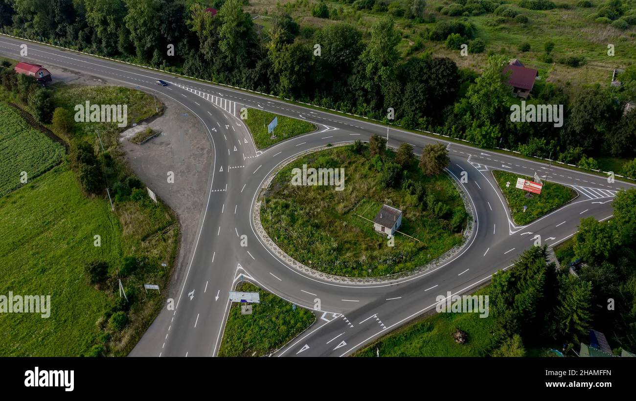 Roundabout traffic of cars and trucks on the circle ring road aerial ...