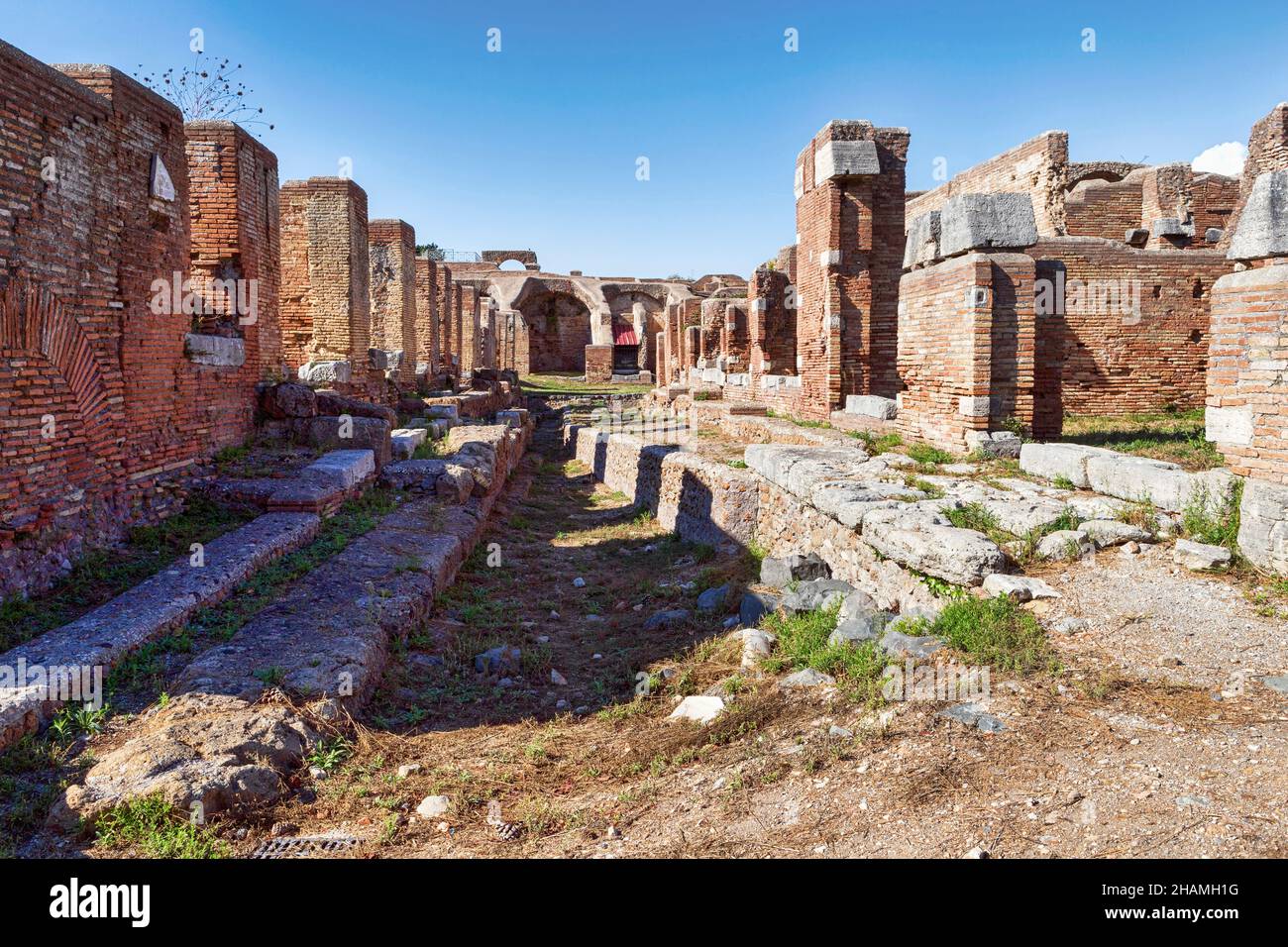 Suggestive street view in ancient Roman village with ruins and remains ...